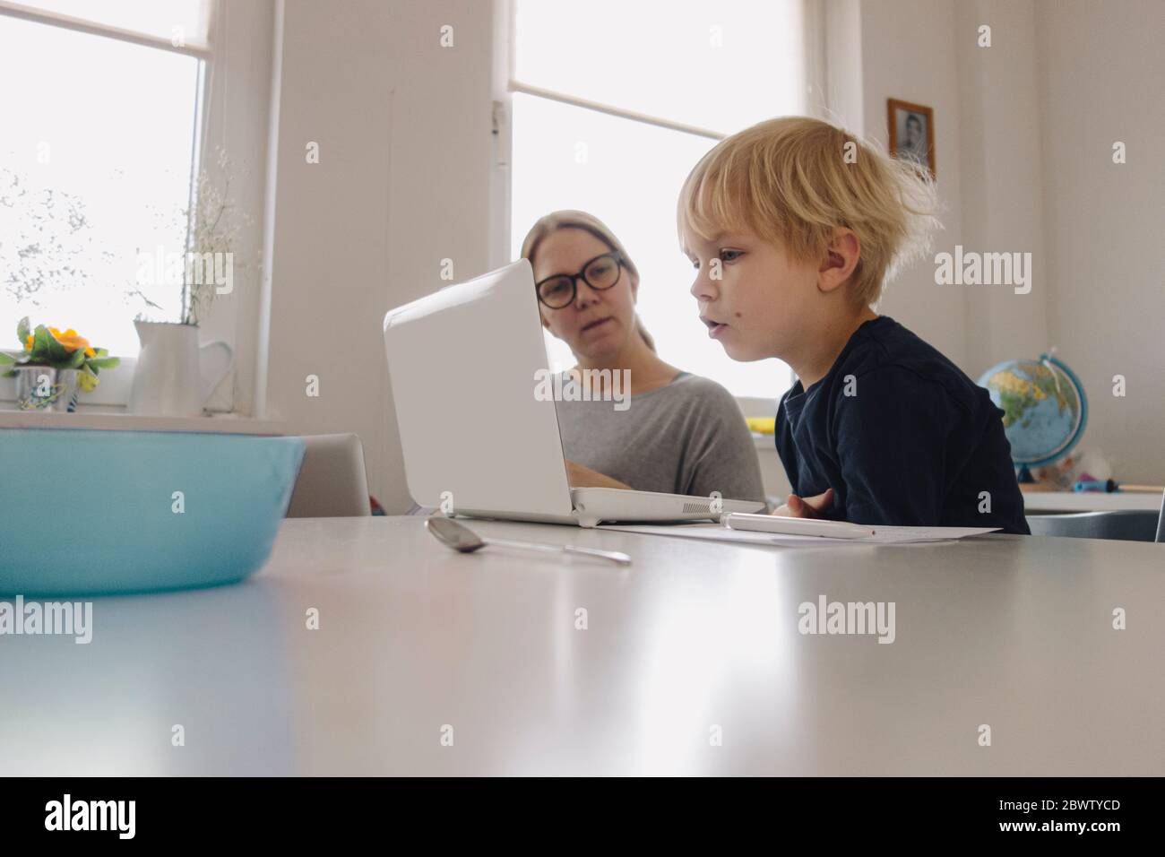 Mother home schooling her son Stock Photo - Alamy