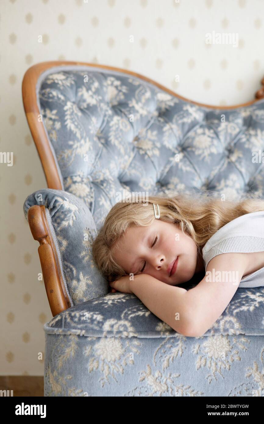 Portrait of a girl sleeping on a couch Stock Photo - Alamy