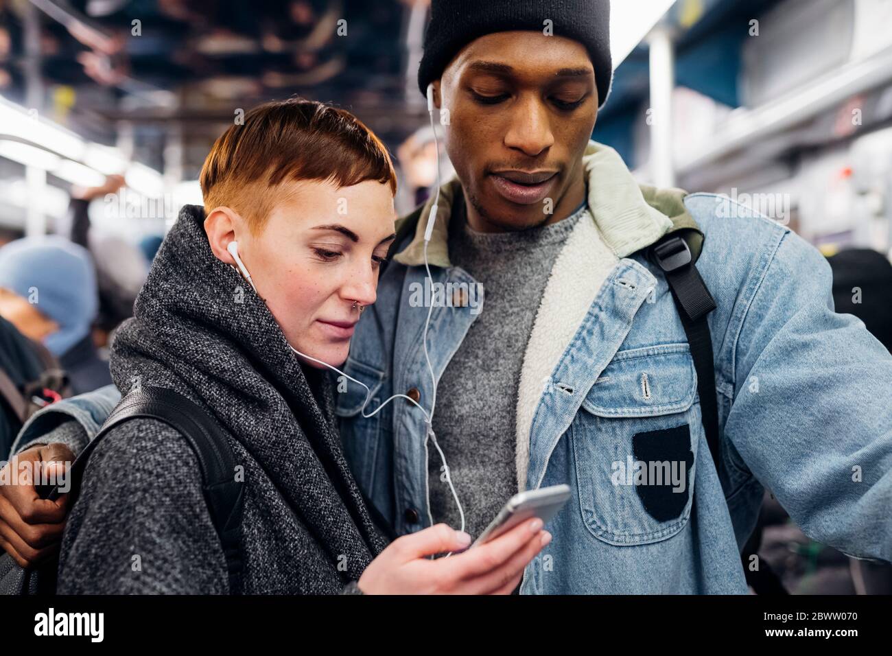 Couple sharing earbuds hi-res stock photography and images - Alamy