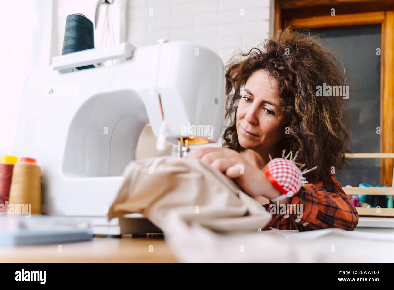 Woman sewing at home Stock Photo - Alamy