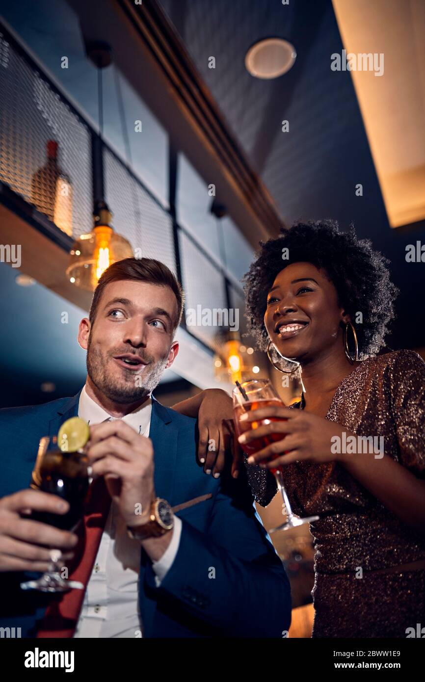 Happy couple socializing in a bar Stock Photo - Alamy