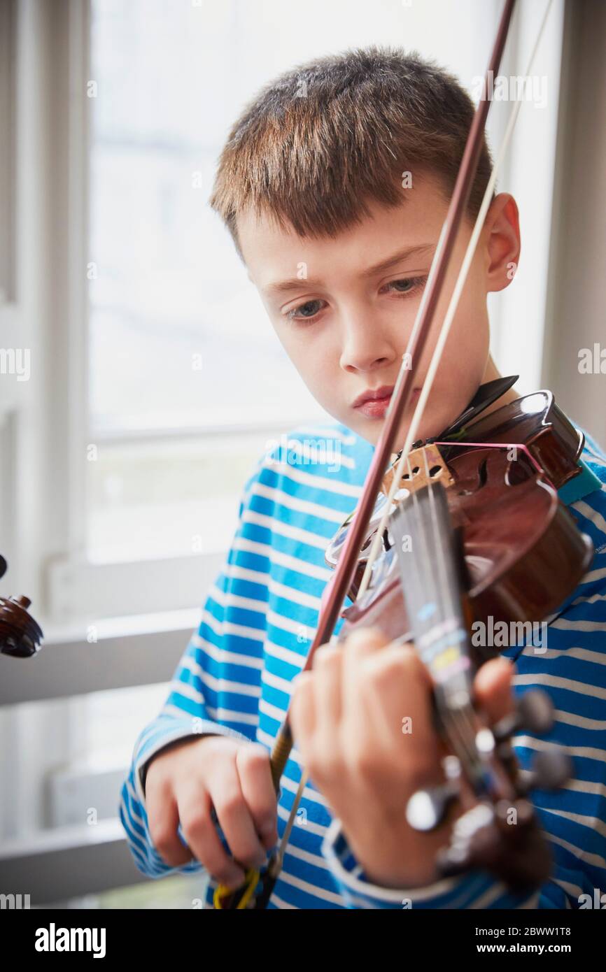 Boy playing violin during a lesson Stock Photo - Alamy