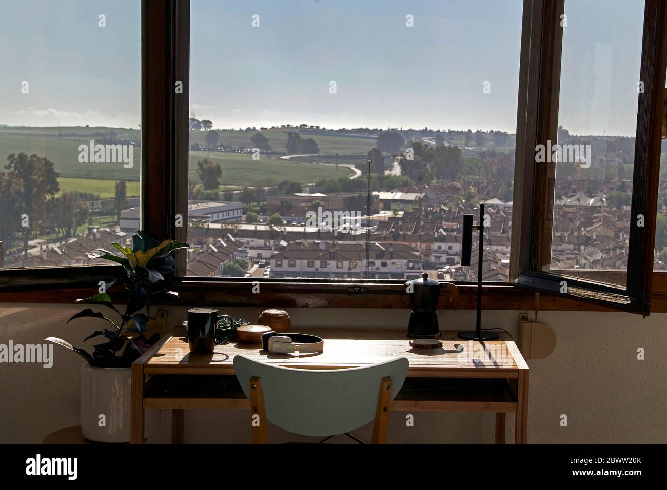 Desk with view at open window Stock Photo - Alamy