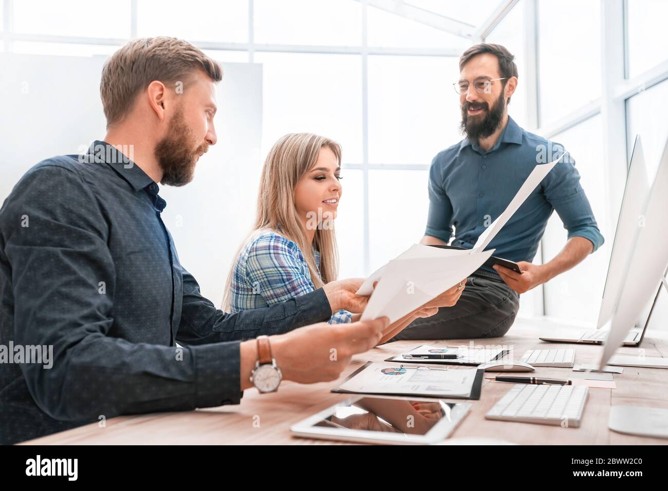 Employees checking together documents hi-res stock photography and ...
