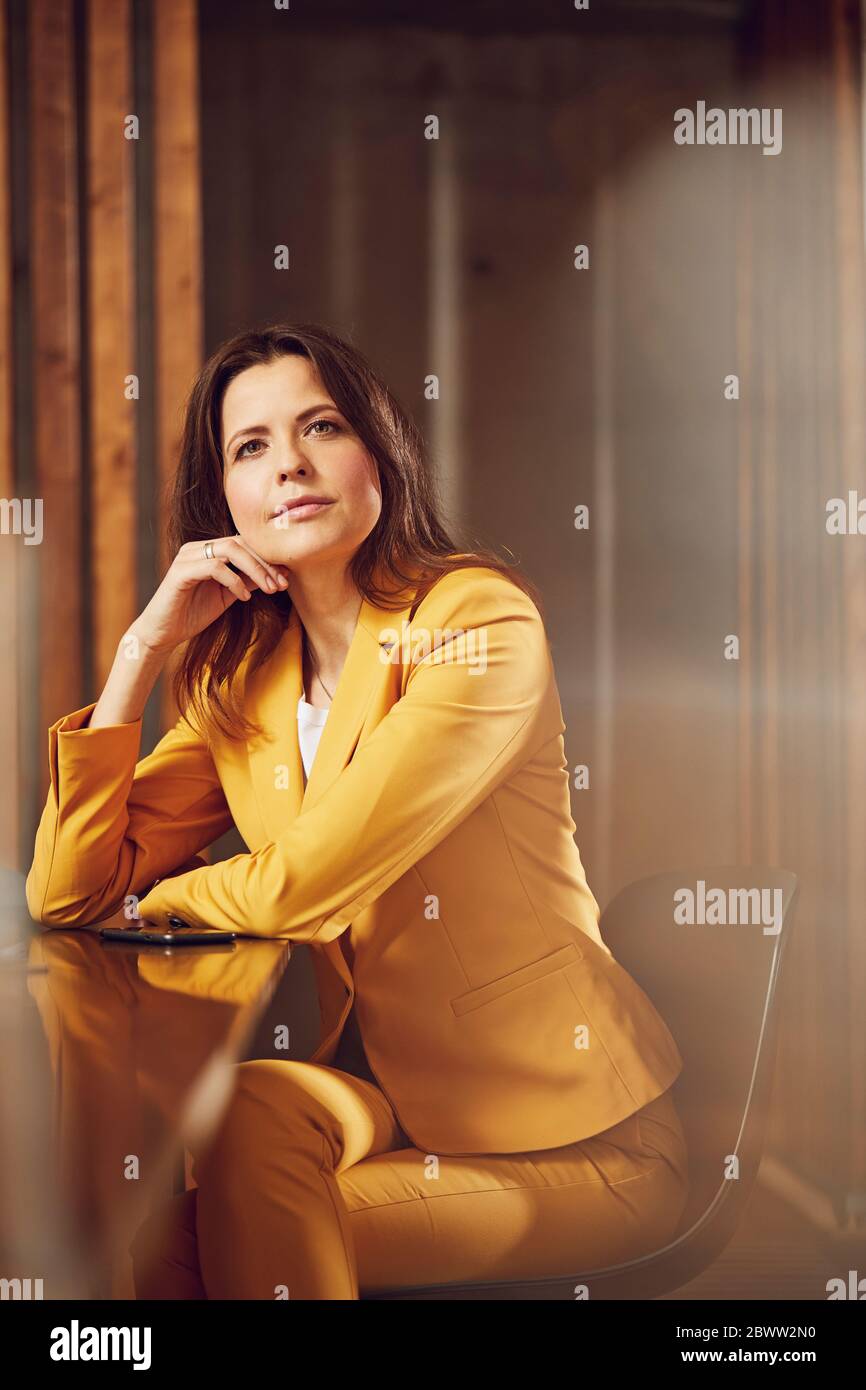 Businesswoman wearing suit sitting desk hi-res stock photography and ...