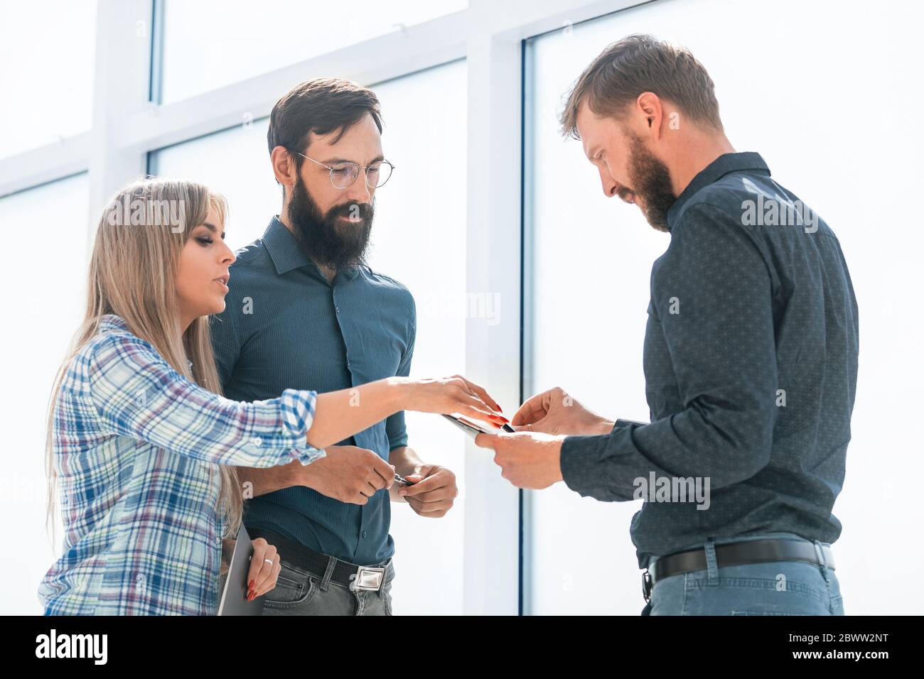 group of employees standing in the office corridor Stock Photo - Alamy