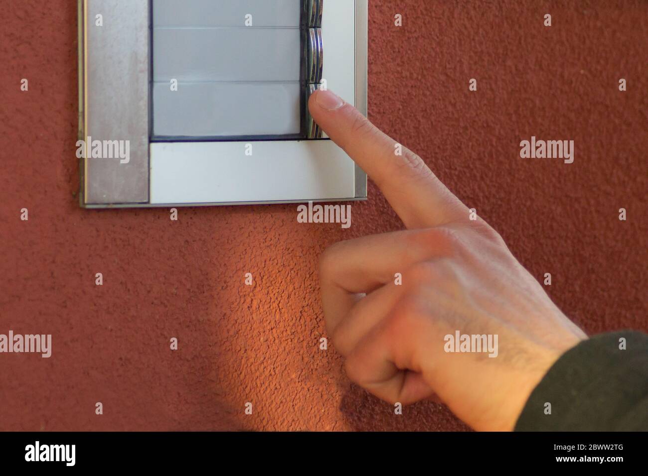 Man hand using intercom Stock Photo - Alamy