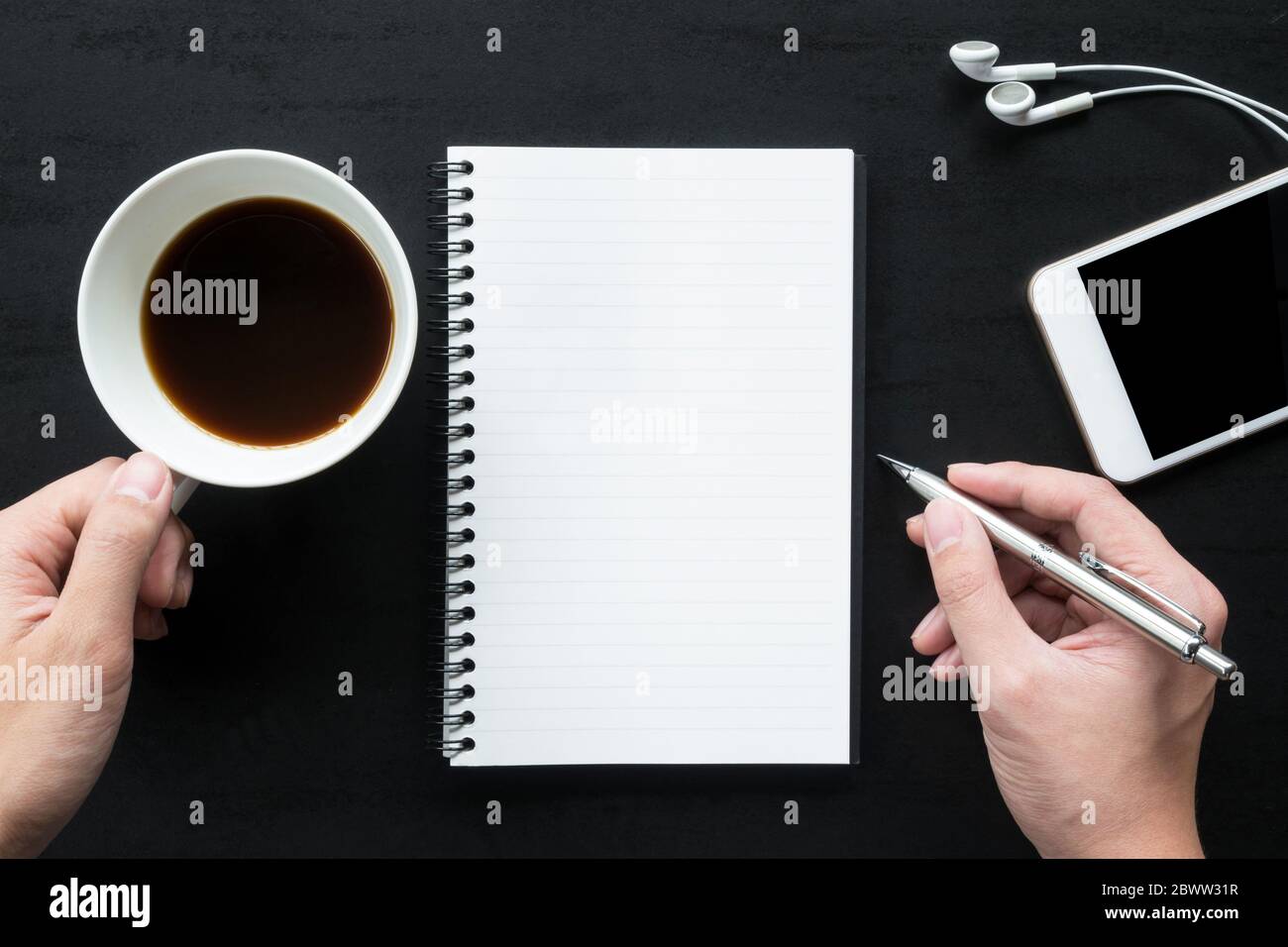 Man is going to write on the notebook. Top view, flat lay Stock Photo ...