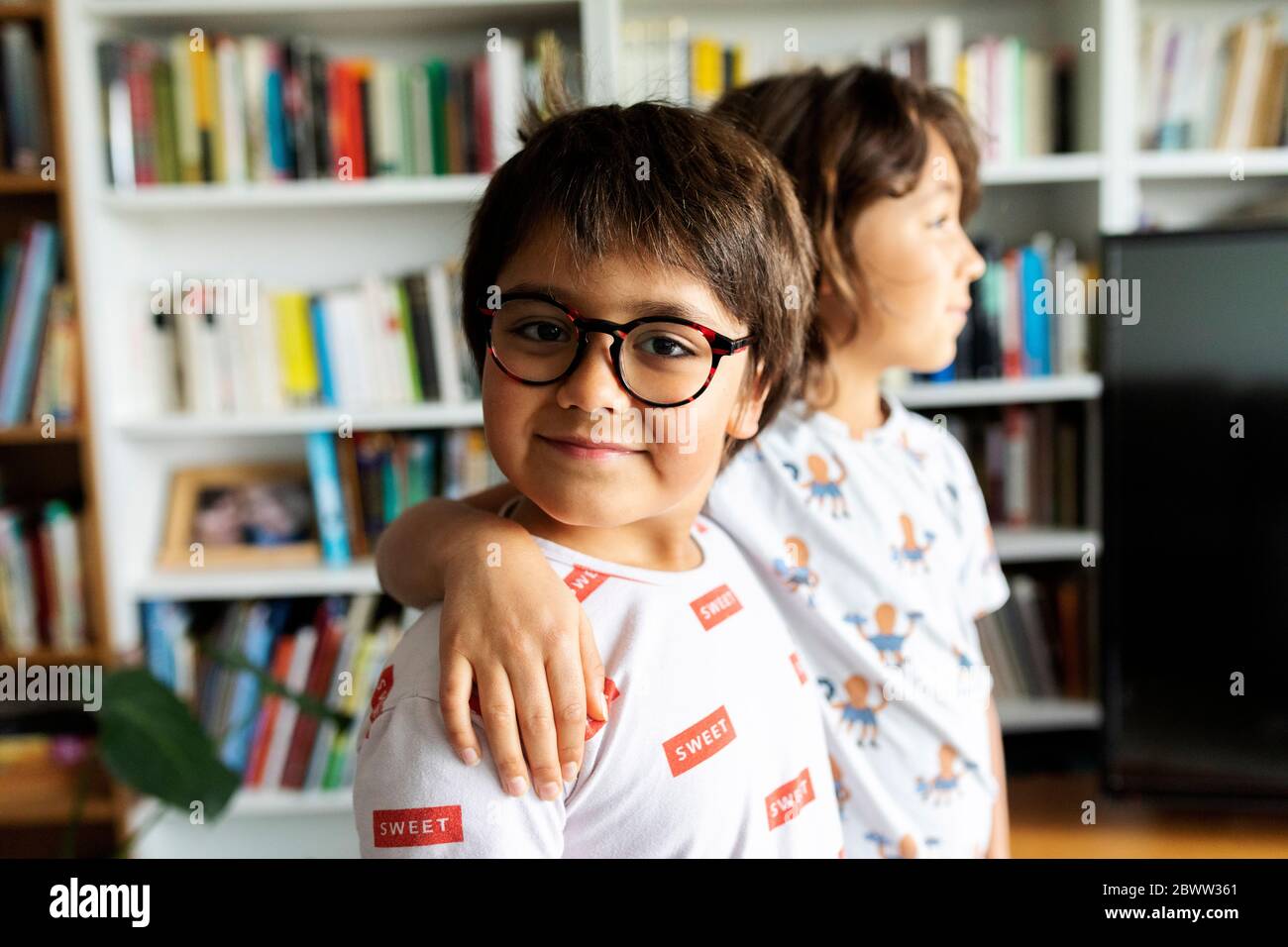 Portrait of relaxed little boy staying at home with his older brother ...