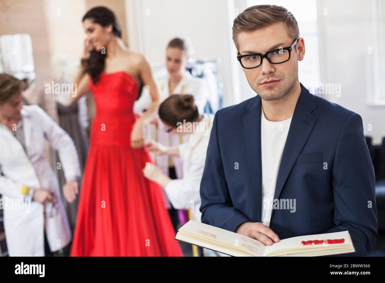 Fashion designer fitting hi-res stock photography and images - Alamy