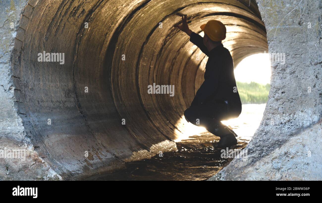 An electrician or builder and engineer, in a blue robe, in a yellow and ...
