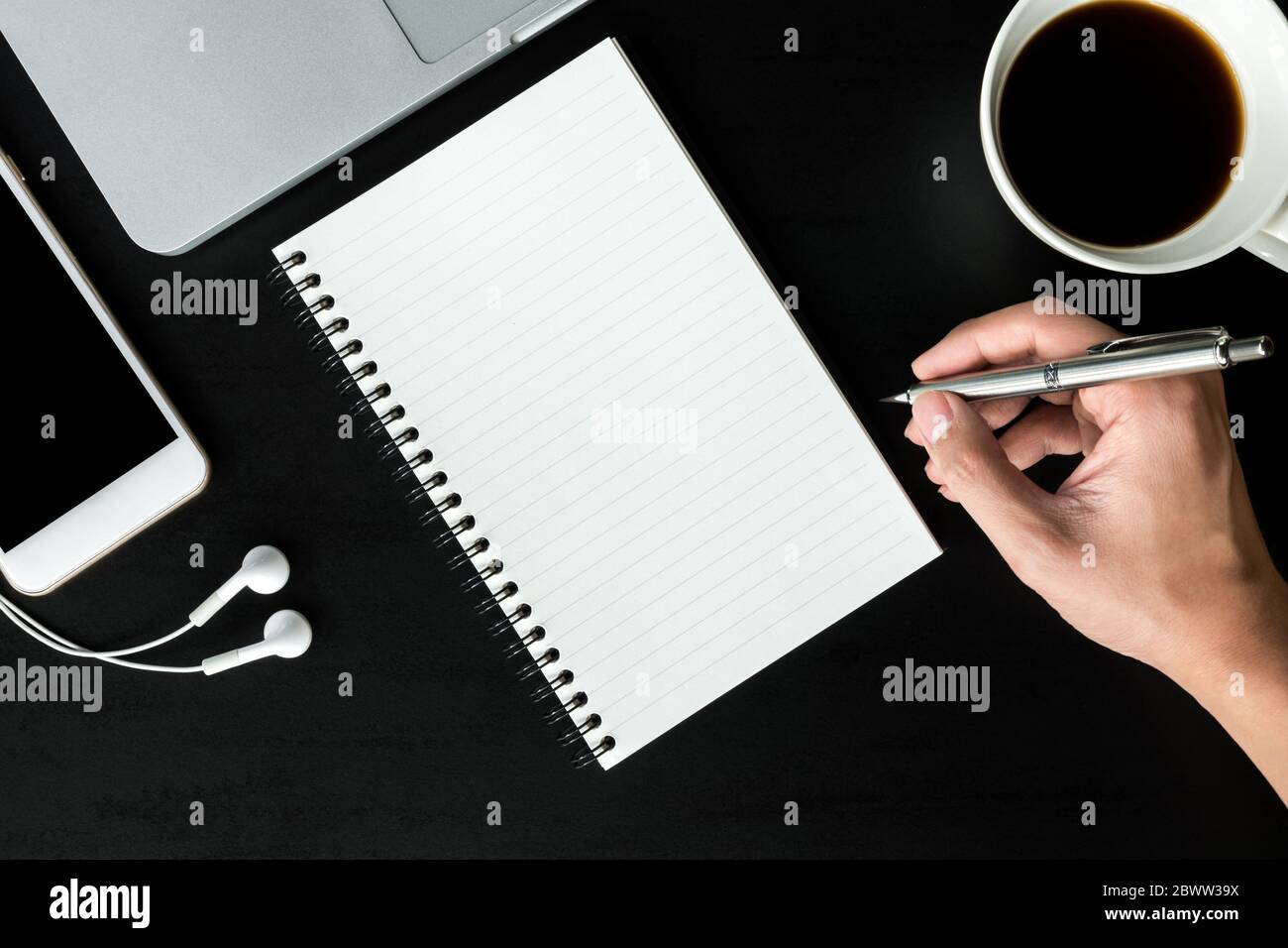 Man is going to write something on the notebook page. Top view with ...