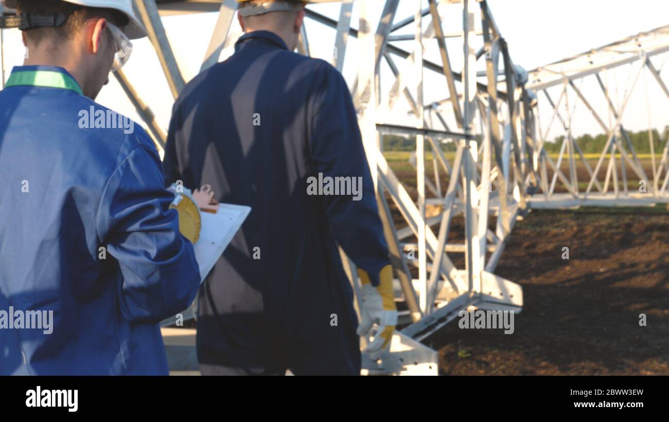 An electrician or builder and engineer, in a blue robe, in a yellow and ...