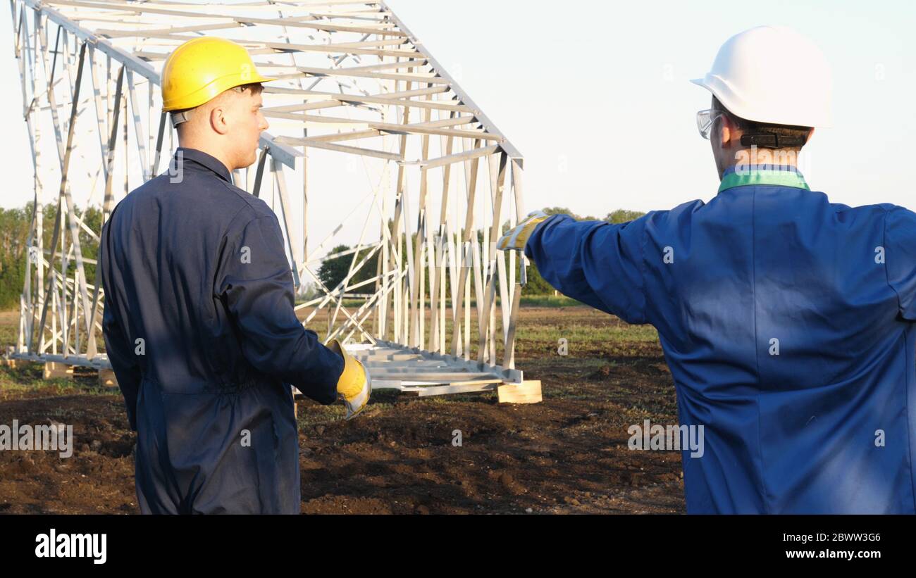 An electrician or builder and engineer, in a blue robe, in a yellow and ...