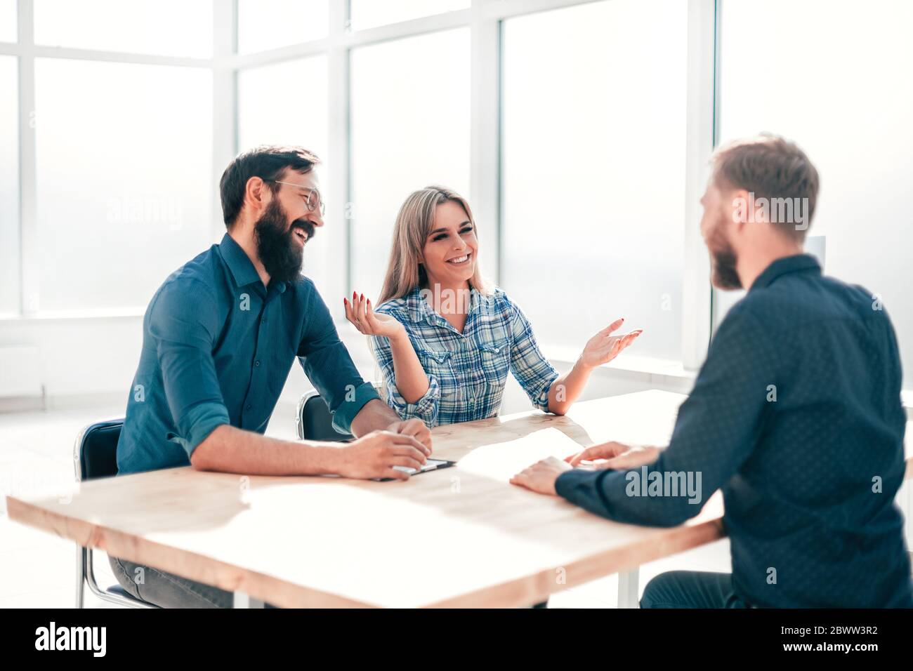 group of business people sitting at the office table Stock Photo - Alamy