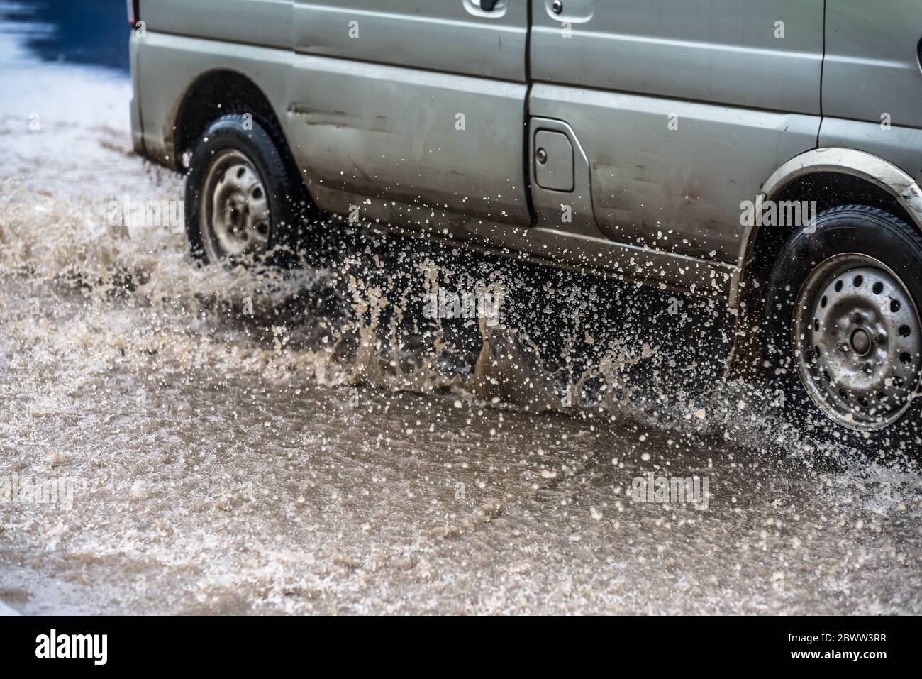 dirty water splash after vehicle roaring by Stock Photo - Alamy