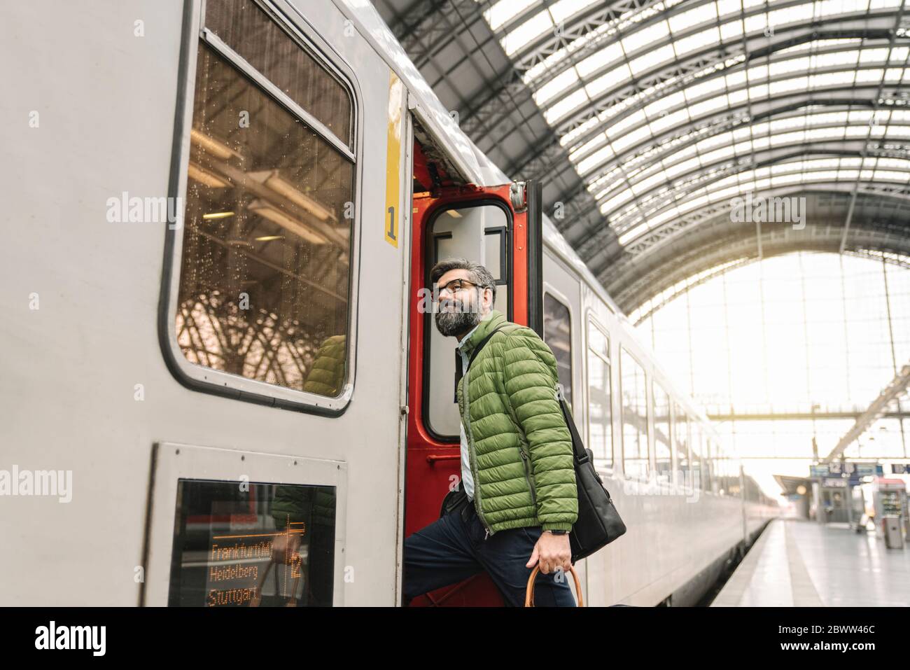 Man getting into a train Stock Photo - Alamy