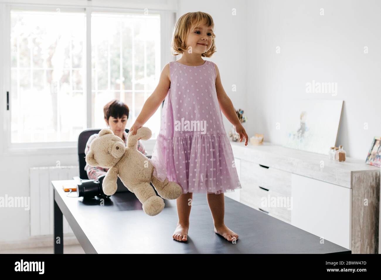 Daughter standing teddy bear on table hi-res stock photography and ...