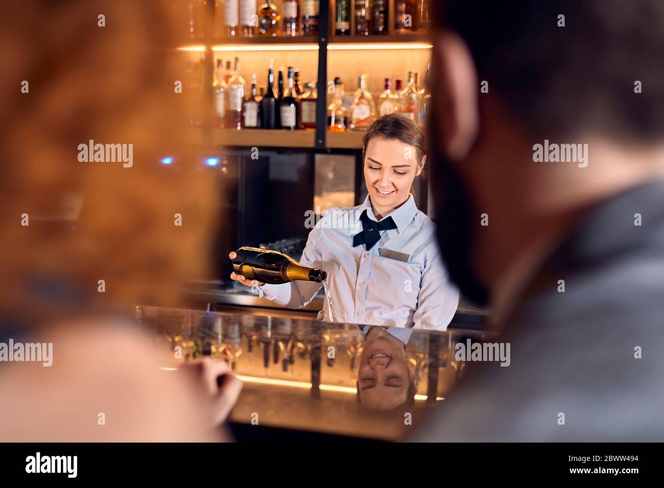 Barwoman preparing drinks in a bar Stock Photo - Alamy