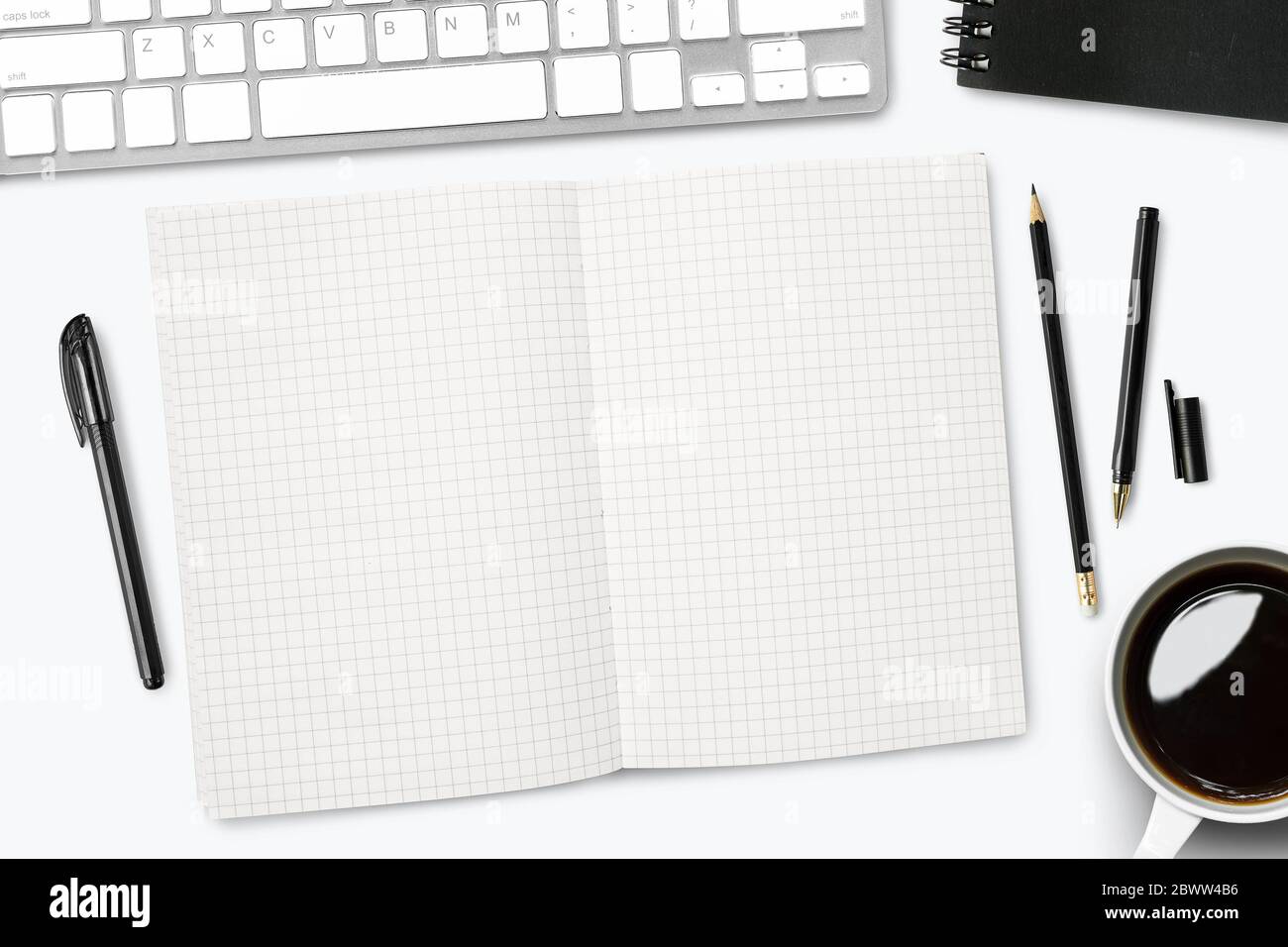 Blank grid lines notebook page on white desk. Top view, flat lay Stock ...