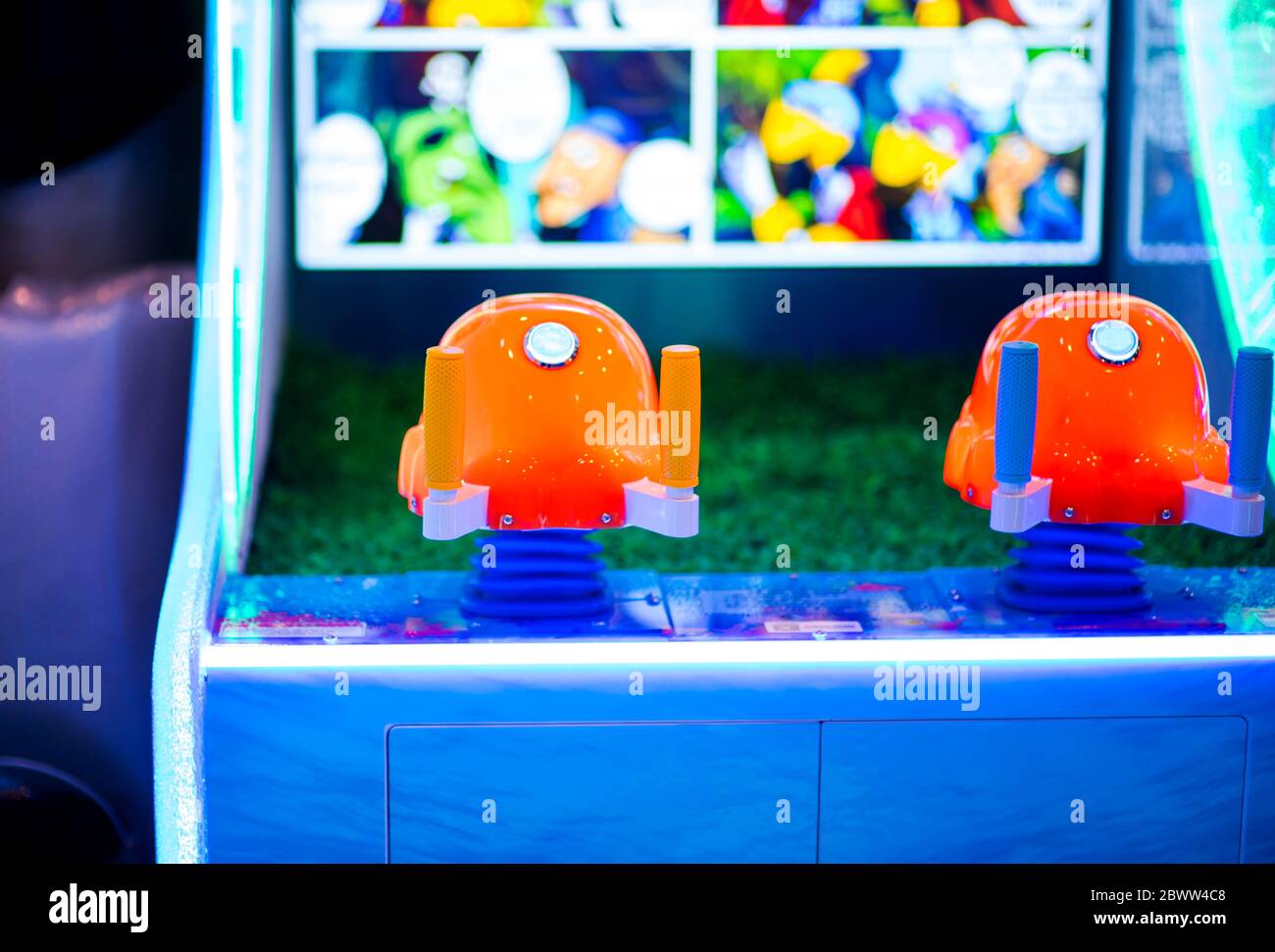 Detail of a joystick and buttons on an old arcade game in a gaming room ...