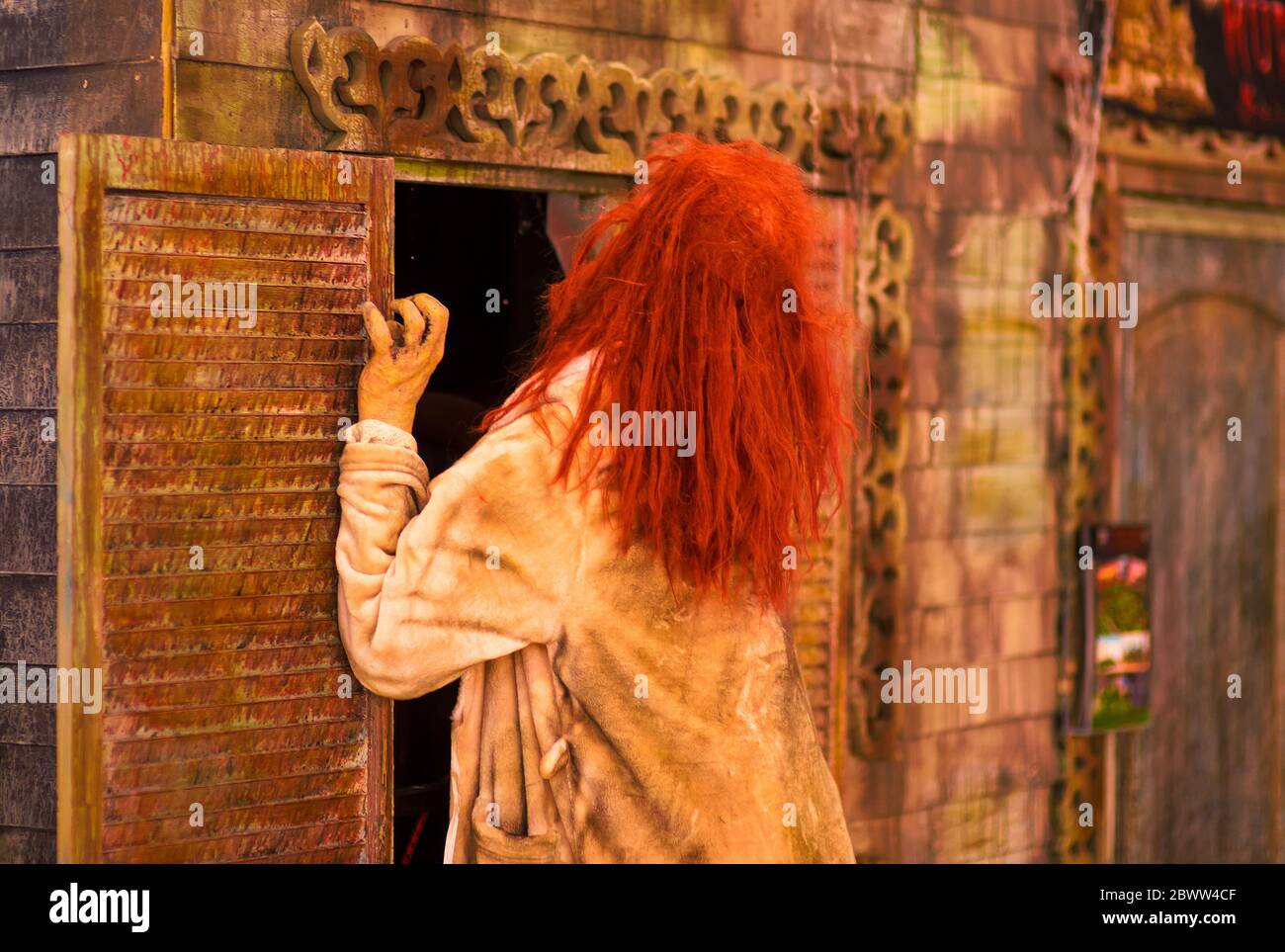 scary witch with red hair by the window Stock Photo - Alamy