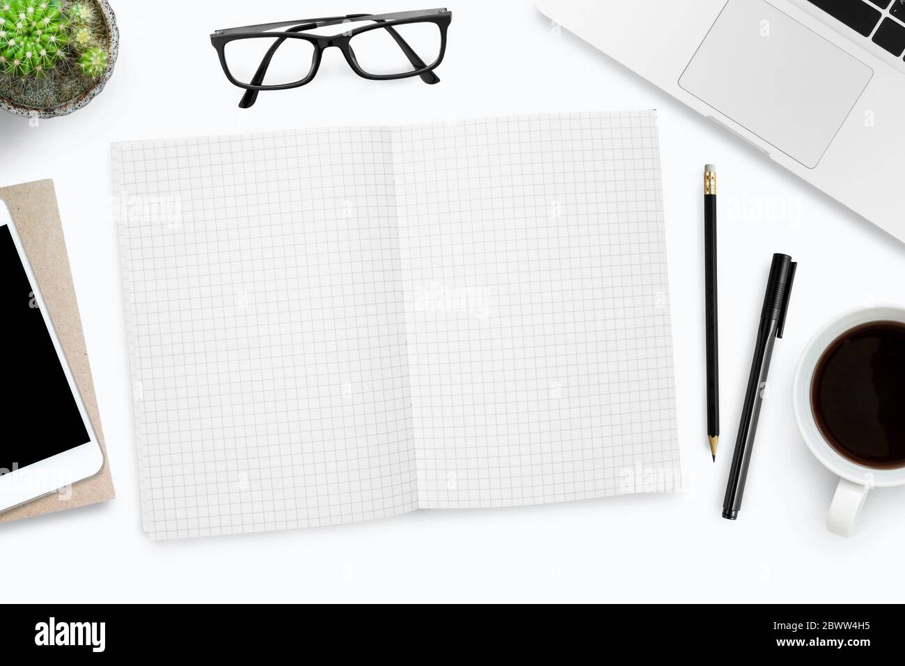 Blank grid lines notebook page on white desk. Top view, flat lay Stock ...