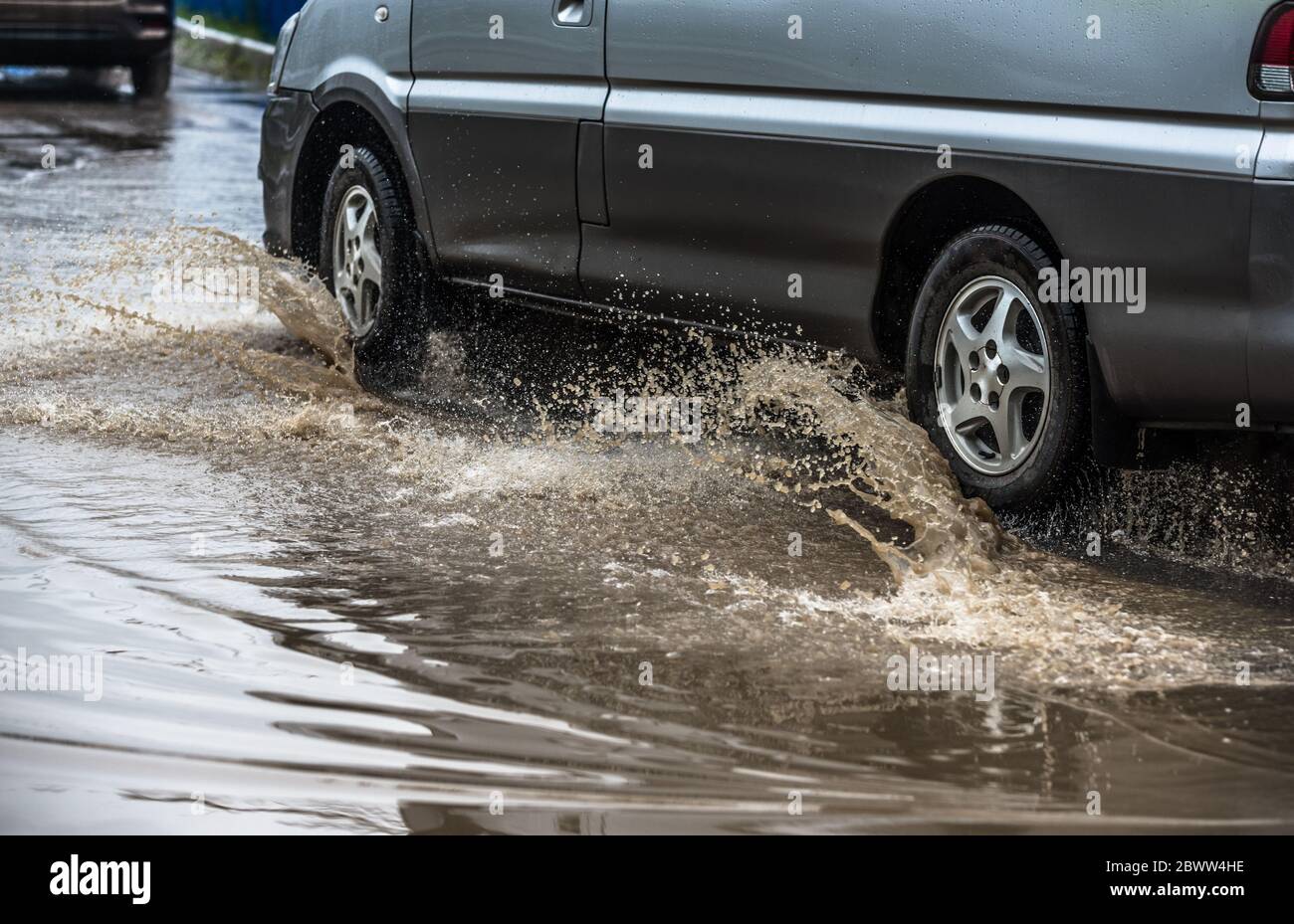 dirty water splash after vehicle roaring by Stock Photo - Alamy