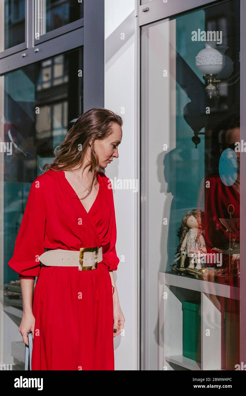 Woman looking in shop window hi-res stock photography and images - Alamy
