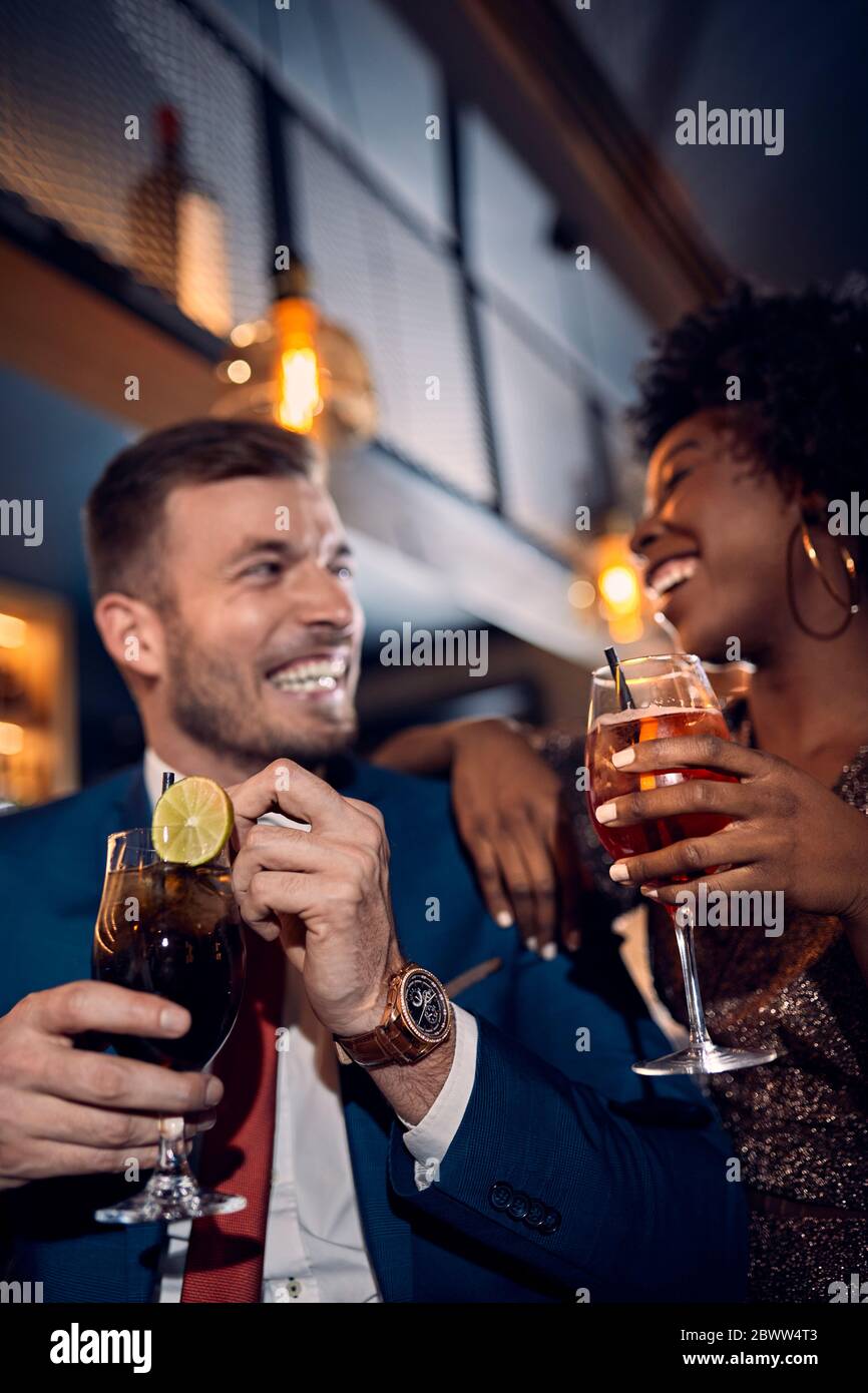 Happy couple socializing in a bar Stock Photo - Alamy