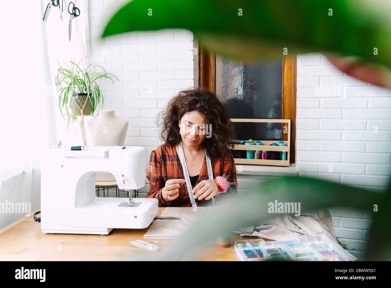 Woman sewing at home Stock Photo - Alamy