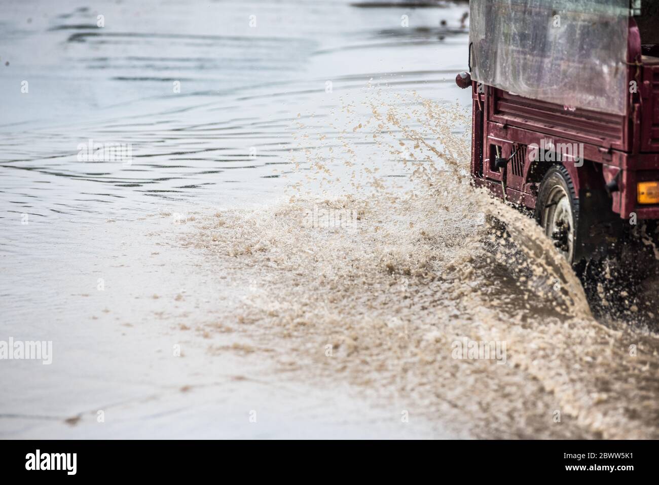 dirty water splash after vehicle roaring by Stock Photo - Alamy