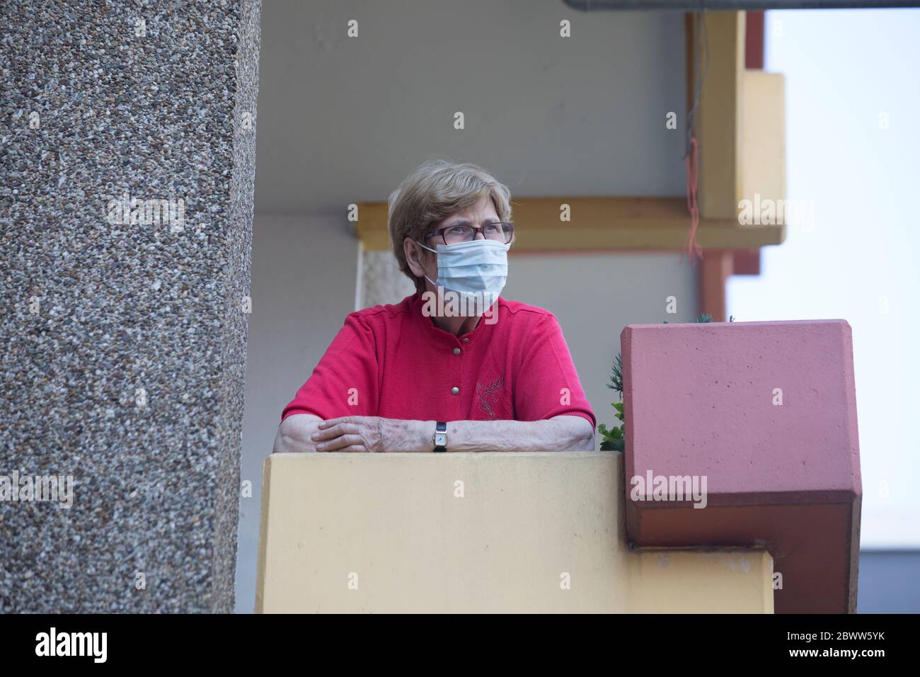 Senior woman wearing mask on balcony, retirement home Stock Photo - Alamy