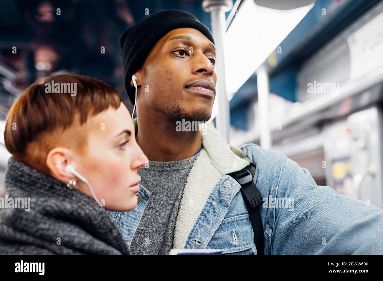 Couple sharing earbuds hi-res stock photography and images - Alamy