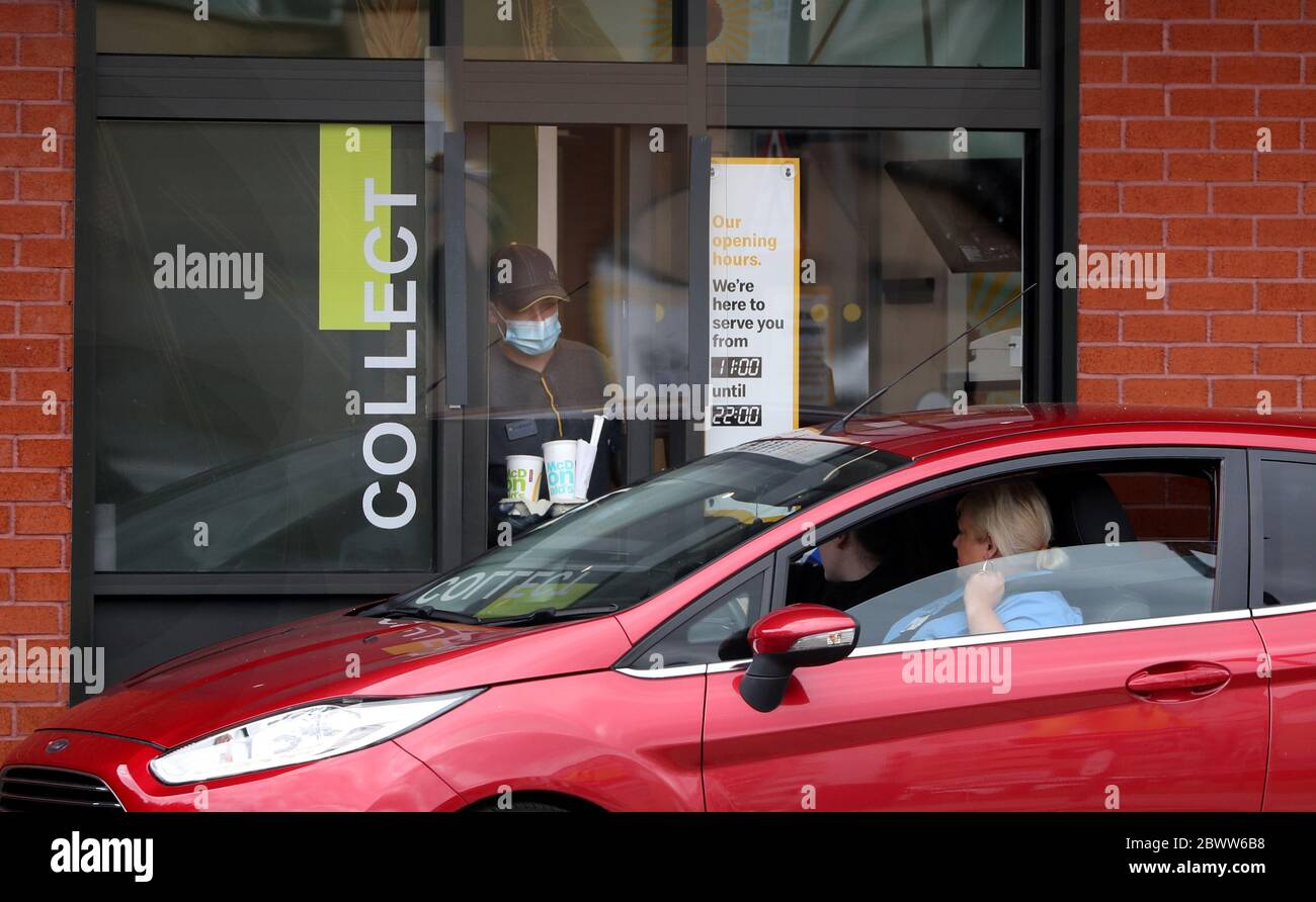 Meals are handed out at the collection window at McDonald's drive thru ...