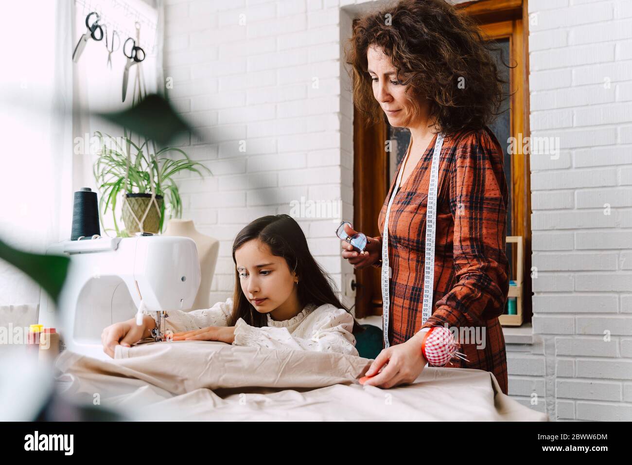 Mother and daughter sewing at home Stock Photo - Alamy