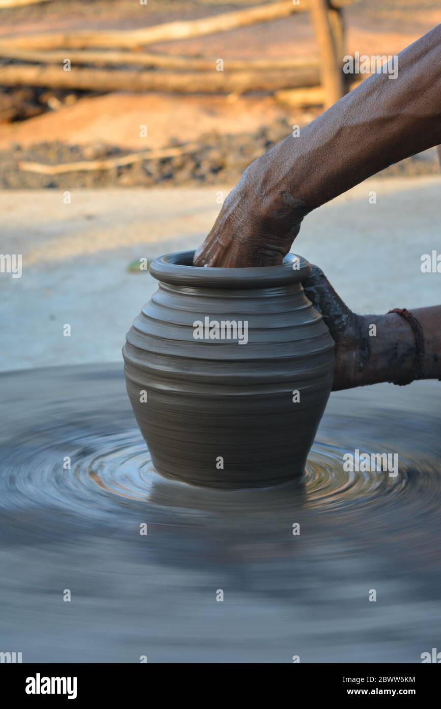 Hands working on pottery wheel and making a pot Stock Photo - Alamy