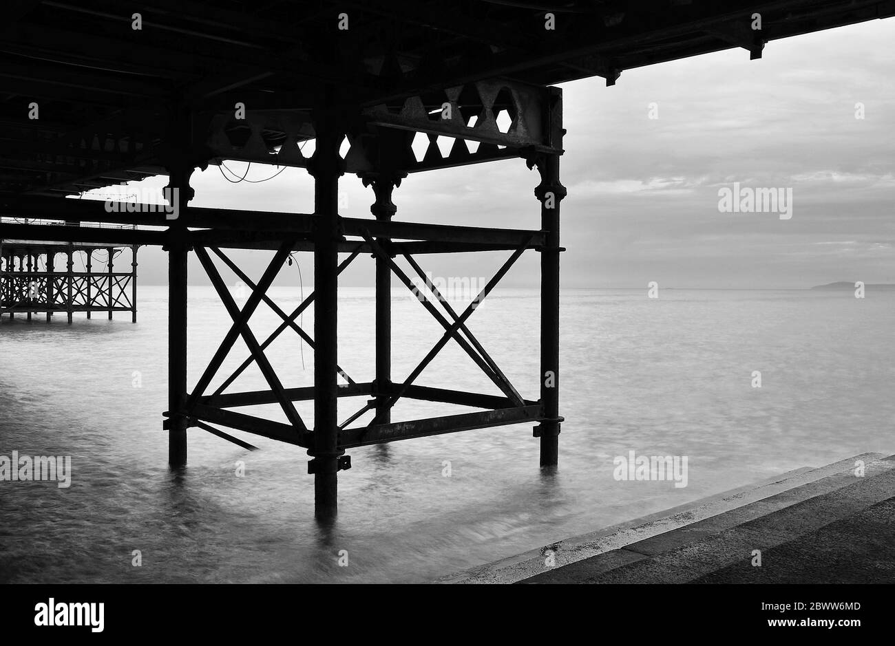 Nightfall and high tide below seaside pier Stock Photo - Alamy