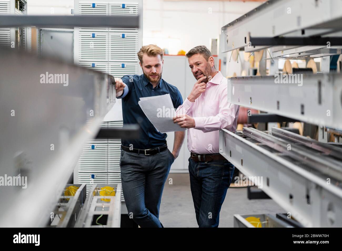 Two men discussing a plan in a factory Stock Photo - Alamy Two men discussing a plan in a factory Stock Photo - Alamy