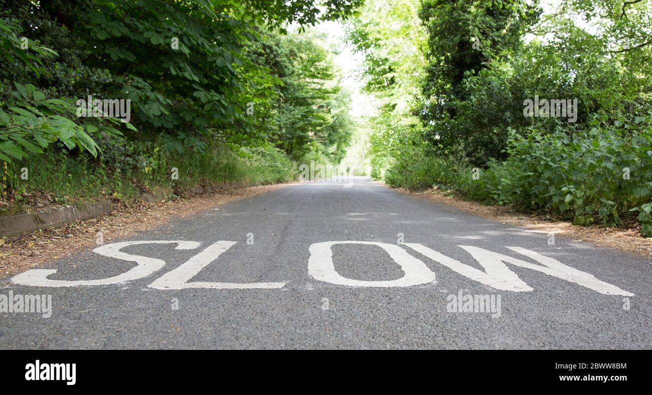 Road marking slow sign painted hi-res stock photography and images - Alamy
