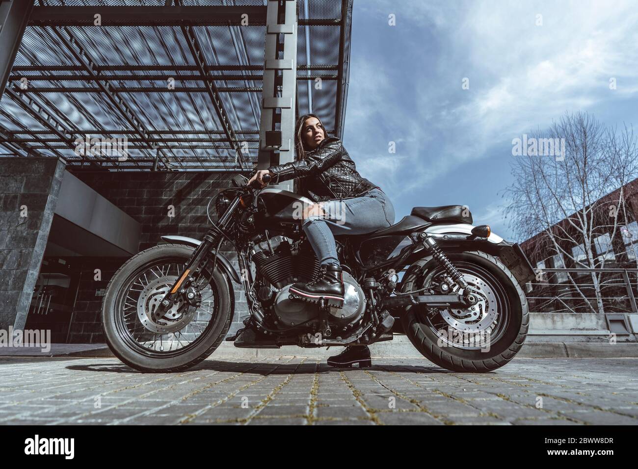 Woman posing on motorcycle hi-res stock photography and images - Alamy