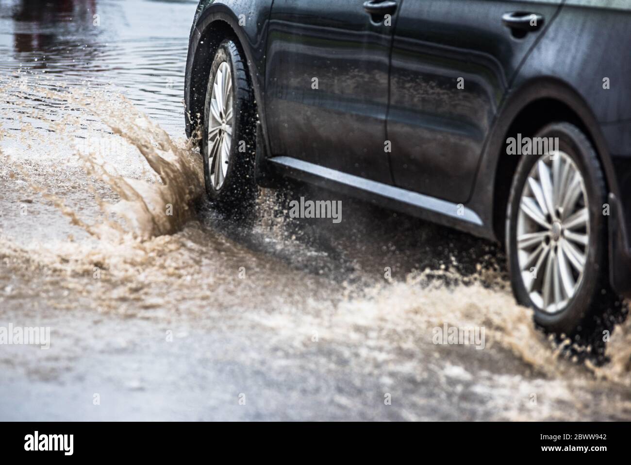 dirty water splash after vehicle roaring by Stock Photo - Alamy