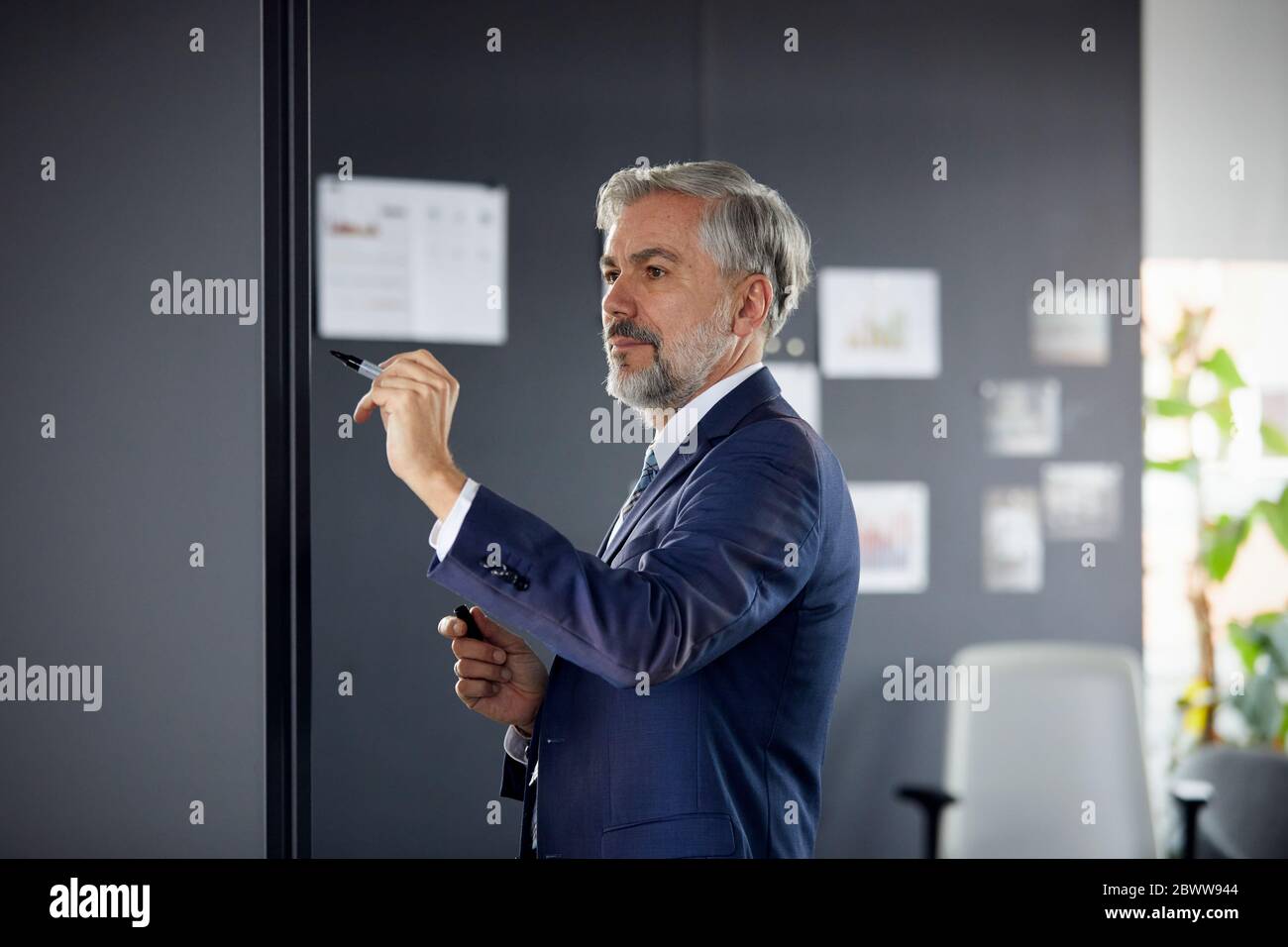Mature businessman brainstorming in office Stock Photo - Alamy