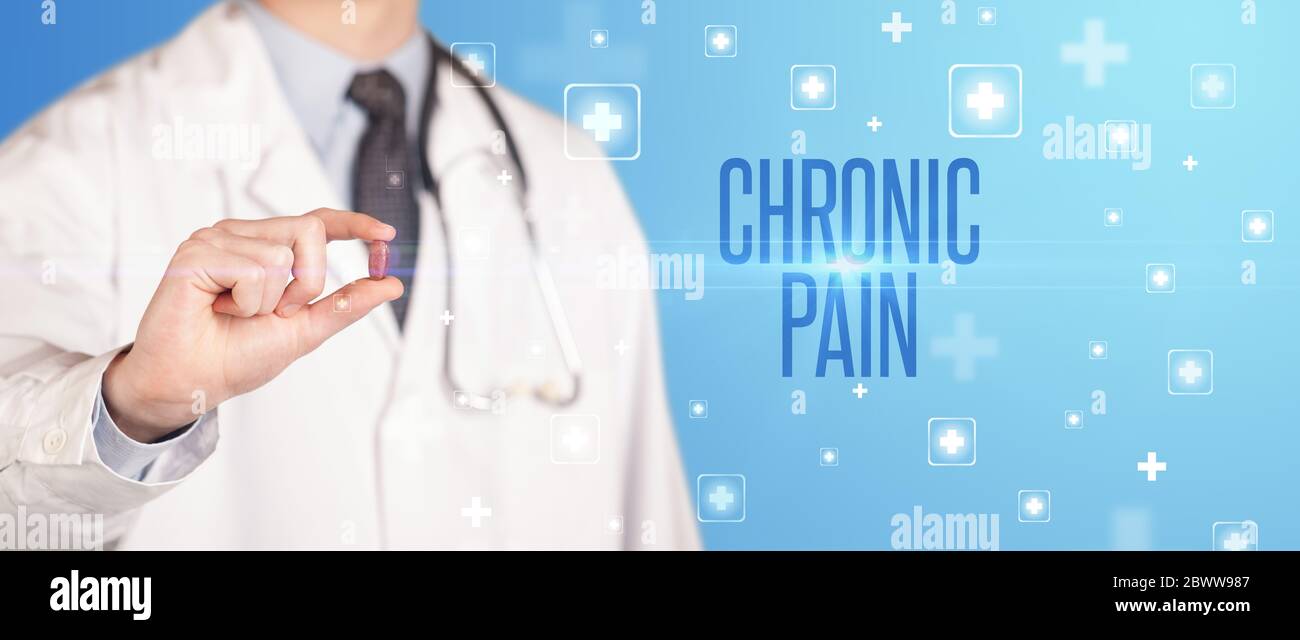 Close-up of a doctor giving a pill with CHRONIC PAIN inscription ...
