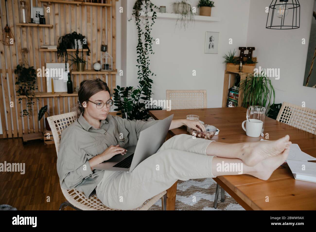 Woman sitting table feet up hi-res stock photography and images - Alamy