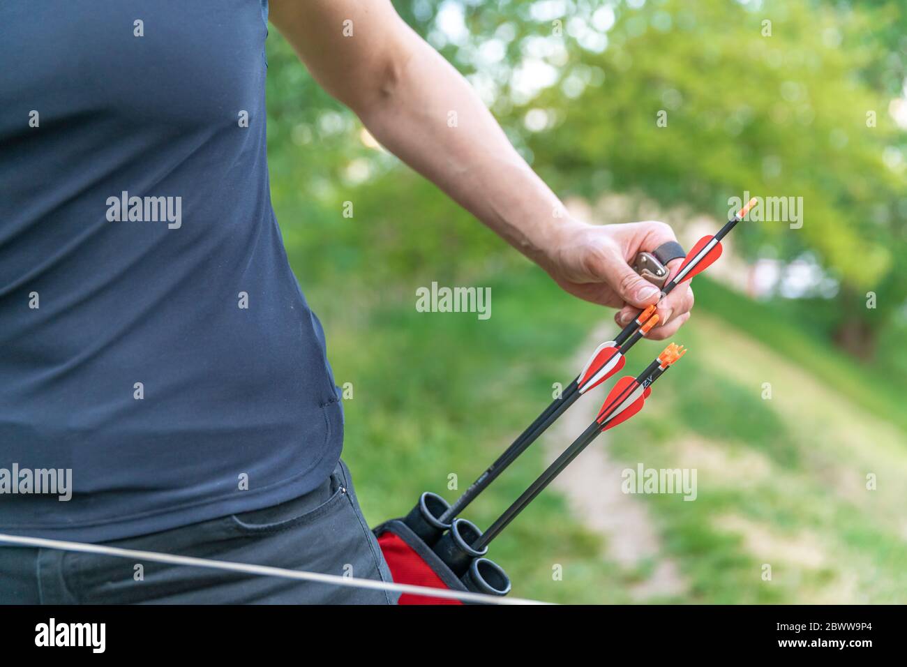 pulling an arrow out of the holster at archery races Stock Photo - Alamy