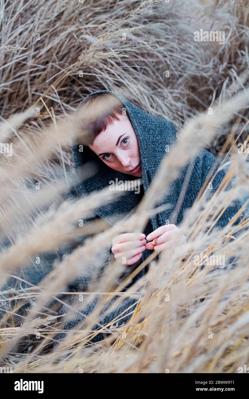 Portrait of young woman among grasses Stock Photo - Alamy