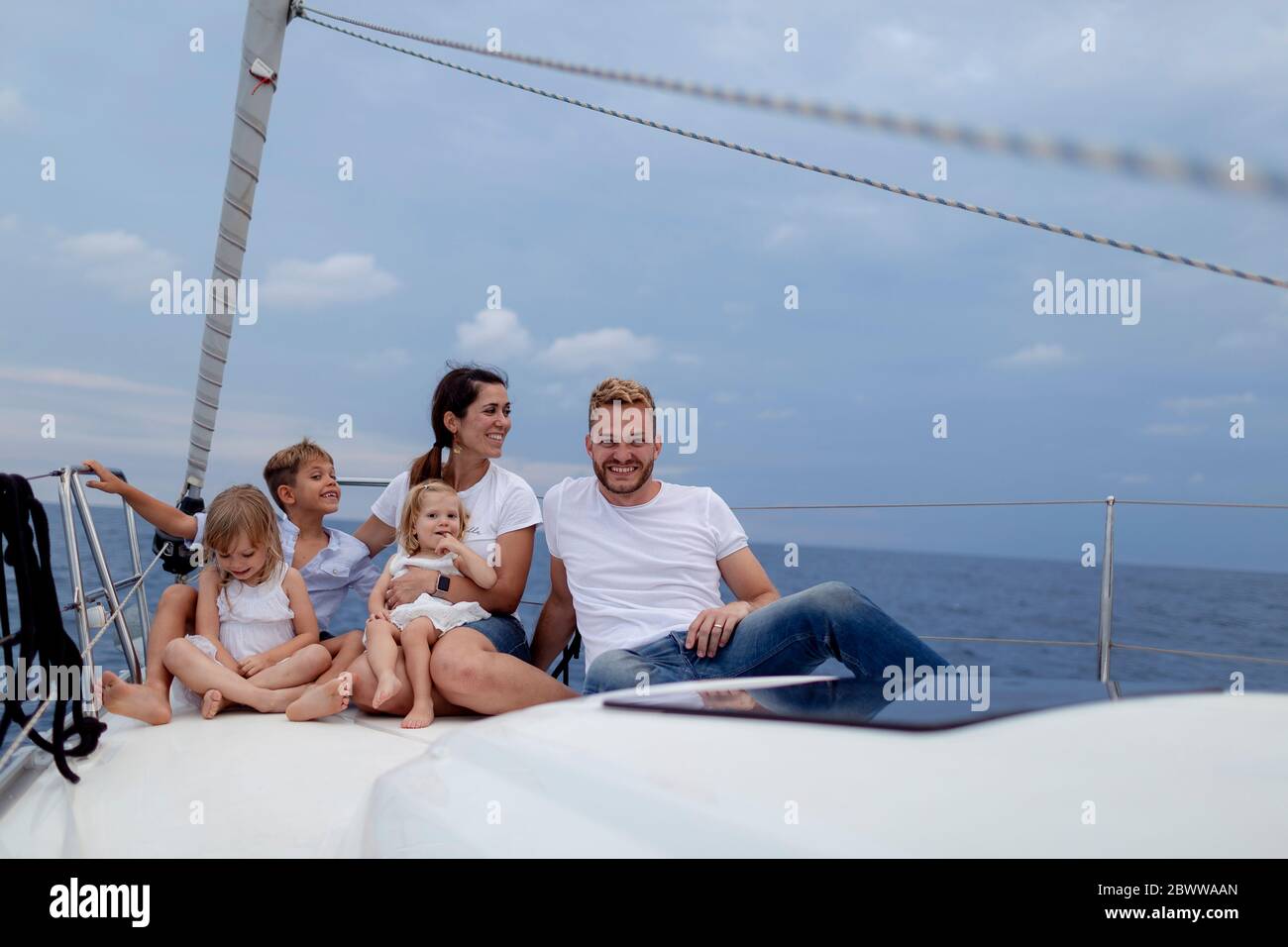 Family sitting on deck during sailing trip Stock Photo - Alamy