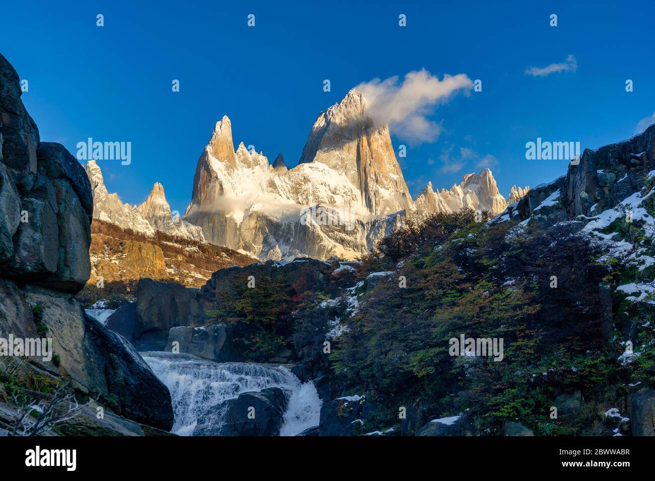 Mount Fitz Roy and waterfall at sunrise in Autumn, El Chalten ...