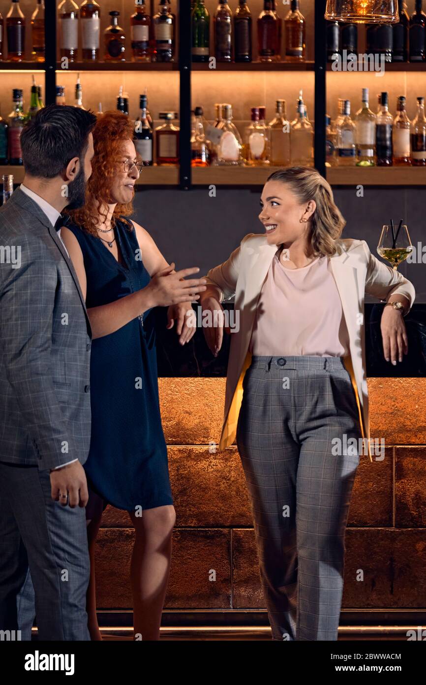 Friends socializing in a bar Stock Photo - Alamy
